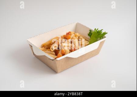 Four takeout meals served in biodegradable containers, featuring pasta ...