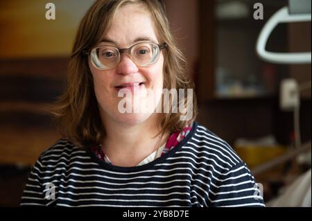 Indoor portrait 42 yo Down Syndrome woman calling her family in ...