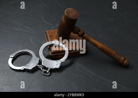 Handcuffs and judge's gavel on grey textured table, closeup Stock Photo ...