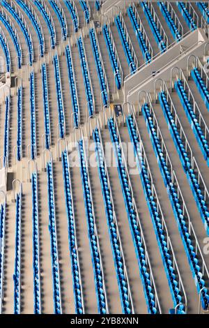 Geometric perspective of empty blue plastic seats. High-angle ...