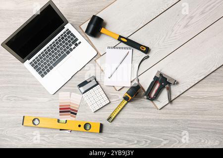 Tools, laptop, color palettes and laminate boards on floor Stock Photo ...