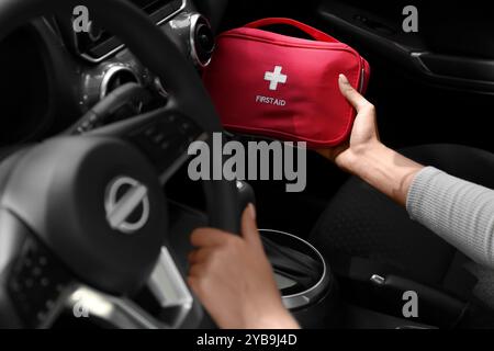 Driver with first aid kit in car Stock Photo - Alamy