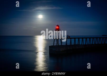 The moon rises over Whitby harbour Stock Photo - Alamy
