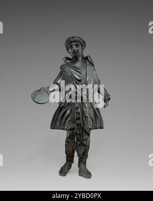 Bronze statuette of a Roman male offering figure, wearing a tunic and ...
