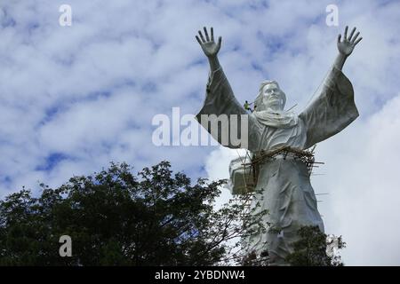 Workers take care of one of Manado popular landmarks, the giant Jesus ...