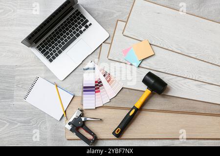 Tools, laptop, color palettes and laminate boards on floor Stock Photo ...