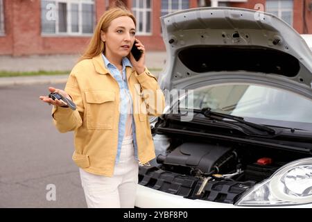 Mature woman with key near car outdoors Stock Photo - Alamy