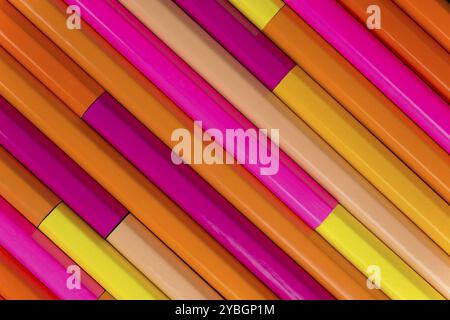 Collection of coloured pencils in a diagonal line pattern as background ...