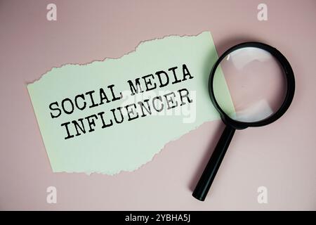 Social Media Influencer text written on paper torn with magnifying ...