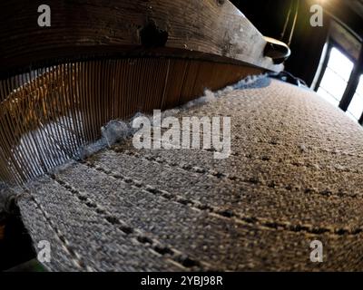 An Old wooden hand loom. Ancient weaving loom in interior of wooden log ...
