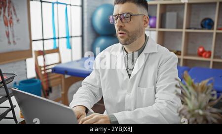 Hispanic man with beard working at therapy office holding call me sign ...