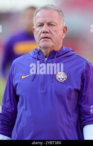 LSU head coach Brian Kelly, right, holds up the trophy after defeating ...