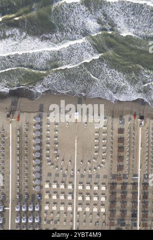 Aerial view of Versilia beach with rough sea photographed from above ...