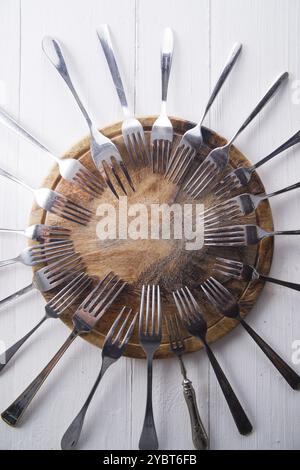 Sets of forks different shapes arranged on chopping round Stock Photo ...