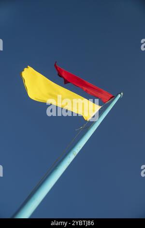 Yellow and red flags of danger without the supervised beach Stock Photo ...