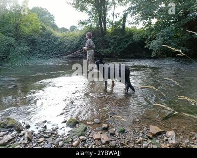 Fishing with a German shepherd Stock Photo - Alamy