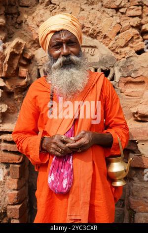 A sadhu poses before a dialopted terracotta mandir of Baidyapur. East ...