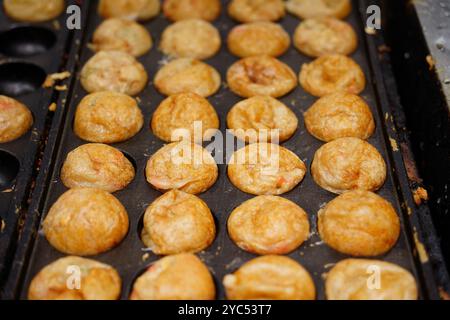 Takoyaki is a Japanese dish made by putting octopus in a flour batter ...
