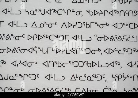 Text in the Inuktitut language displayed on a wall Stock Photo - Alamy