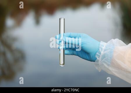 Examination of water quality. Researcher holding test tube with sample ...