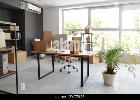 Modern workplace with computer monitor and cardboard boxes in office on ...
