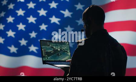 US Air Force dispatcher looking at surveillance transmission on device ...