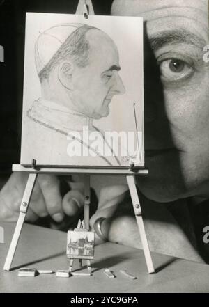 French artist Roger Curtiss showing some small painting portraits of ...