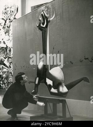 French artist Raymond Moretti with one of his paintings, 1965 Stock ...