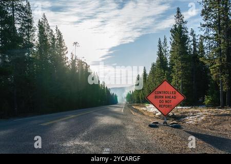 Controlled burn sign along road warning motorists of a prescribed burn ...
