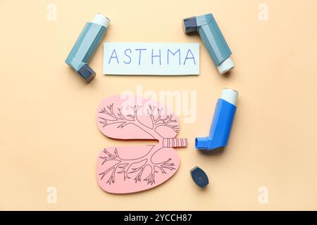 Inhalers and paper sheet with text ASTHMA on beige background Stock ...