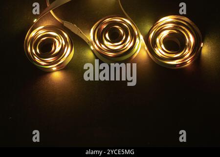 A stack of LED lights on coiled flexible lighting strips, colored blue ...
