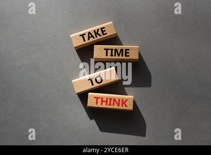 Take time to think symbol. Wooden blocks with words Take time to think ...