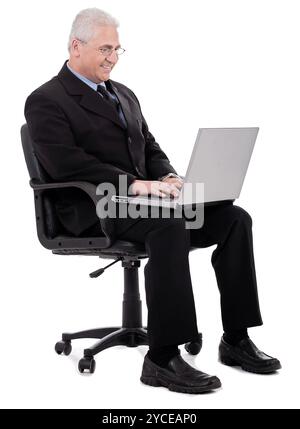 Busy older business man manager working on computer writing notes in ...