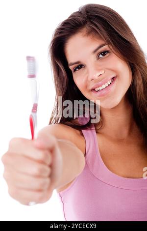 Beautiful young happy woman with toothbrush and paste on brown ...