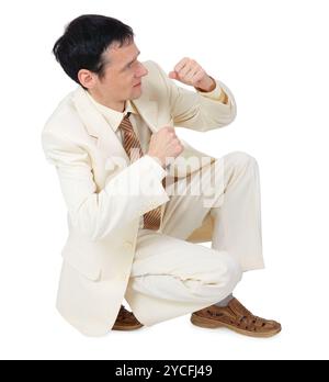 Young businessman in defensive pose afraid of something isolated on ...