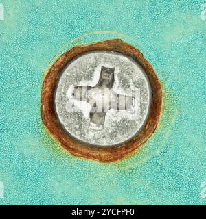 Screw head with cross slots - close-up on blue surface Stock Photo - Alamy