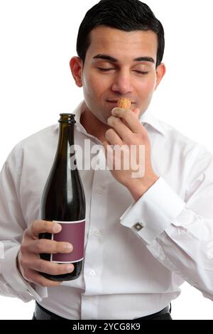 Waiter smelling cork of a wine bottle Stock Photo - Alamy