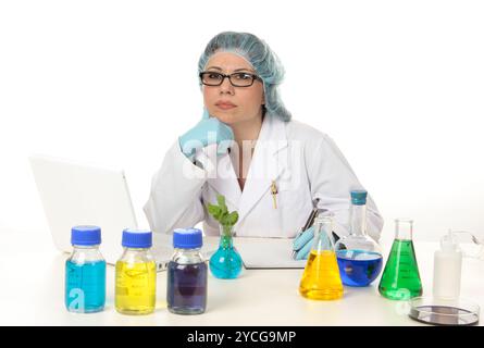 Female geneticist working in laboratory, injecting additives into apple ...