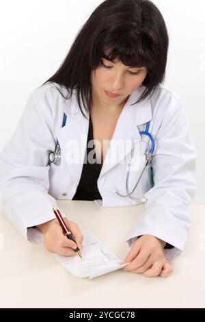 Female doctor writing a script for medicine Stock Photo - Alamy