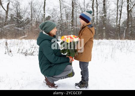 Happy mother accepts a gift from her little daughter. Congratulations ...