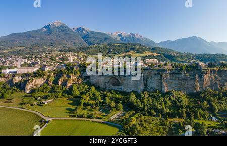Embrun, France, and its cliff Le Roc in the French Alps. Aerial view of ...
