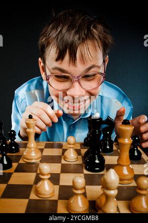 Nerd play chess on a black background Stock Photo - Alamy