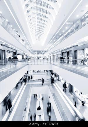 Interior view of a multilevel shopping mall with a vaulted glass ...