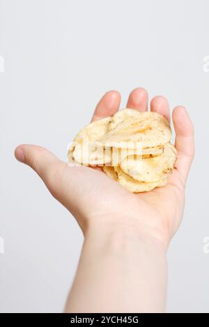 Handful of potato chips Stock Photo - Alamy