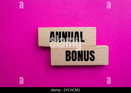 Annual bonus message written on wooden blocks with pink background ...
