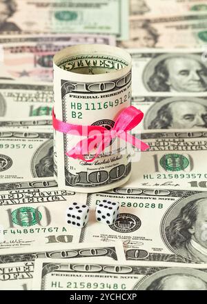US dollars wrapped by ribbon on money background Stock Photo - Alamy