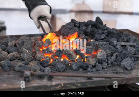 Blacksmith forges a red-hot iron in the forge. Forging hammer of metal ...
