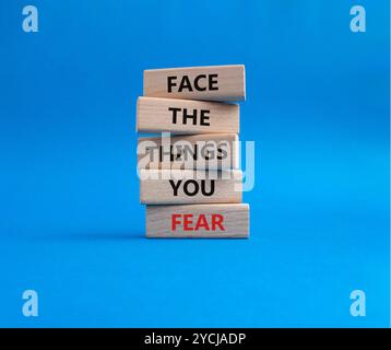 Face the things you fear symbol. Wooden blocks with words Face the ...