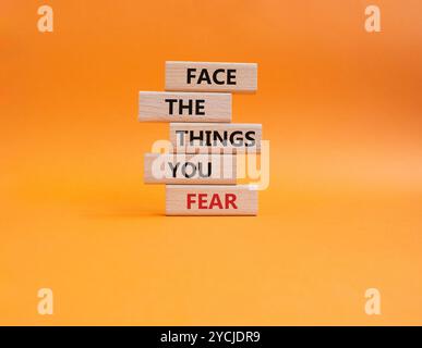 Face the things you fear symbol. Wooden blocks with words Face the ...