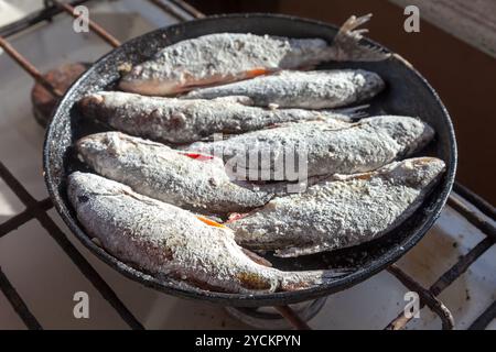 Fried fish in an old pan on the table, top view Stock Photo - Alamy